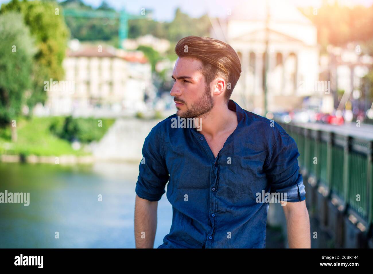 One handsome young man by river in city Stock Photo - Alamy