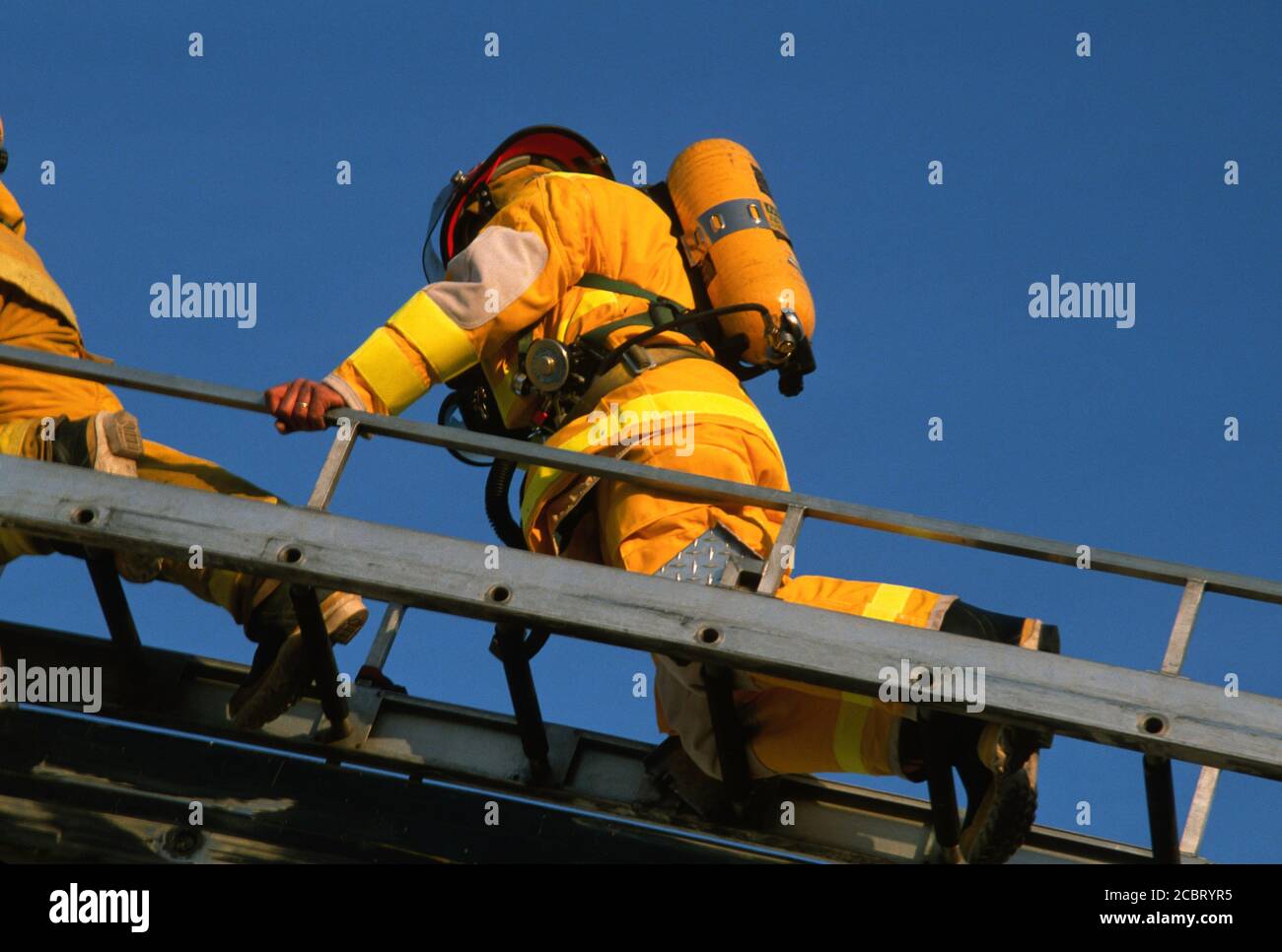 Fireman is climbing up a truck ladder, USA Stock Photo - Alamy