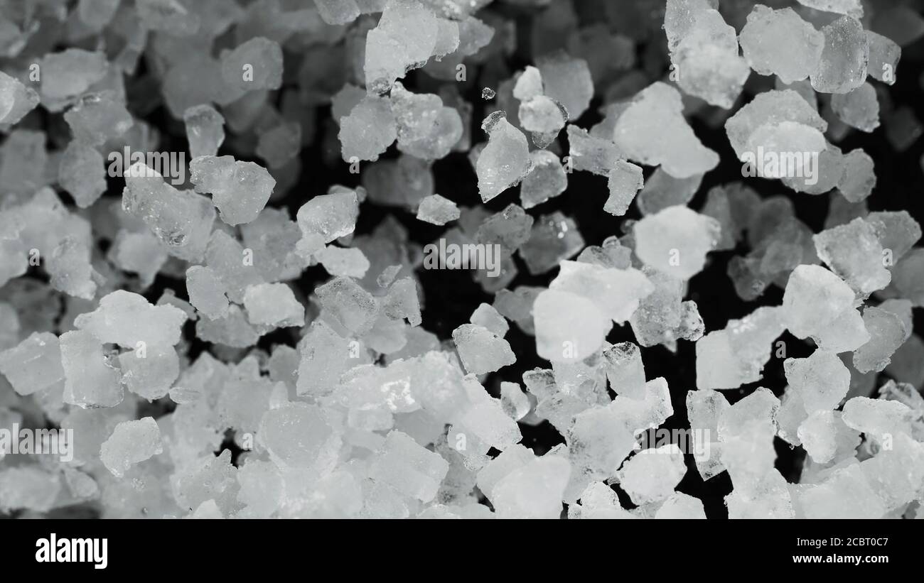 Crushed ice explosion on black background. Freeze motion of flying ...
