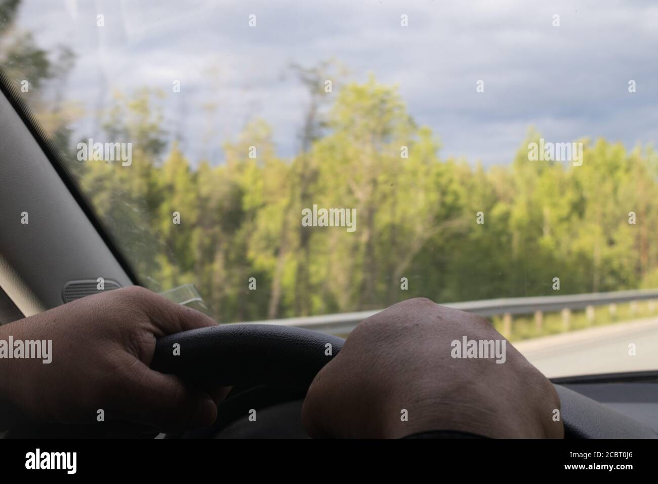 Motion blur. View of the forest road at sunset from the front window of ...