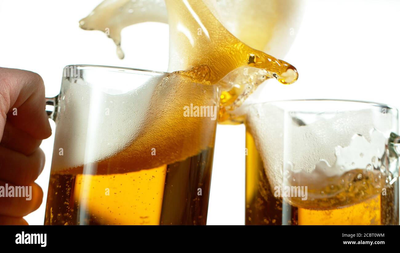cheers, two glass beer mugs isolated on white background. Concept of ...