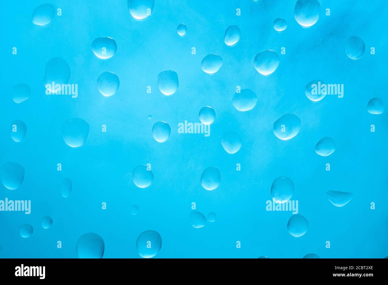 shiny drops of water on a bright blue background an exciting ...