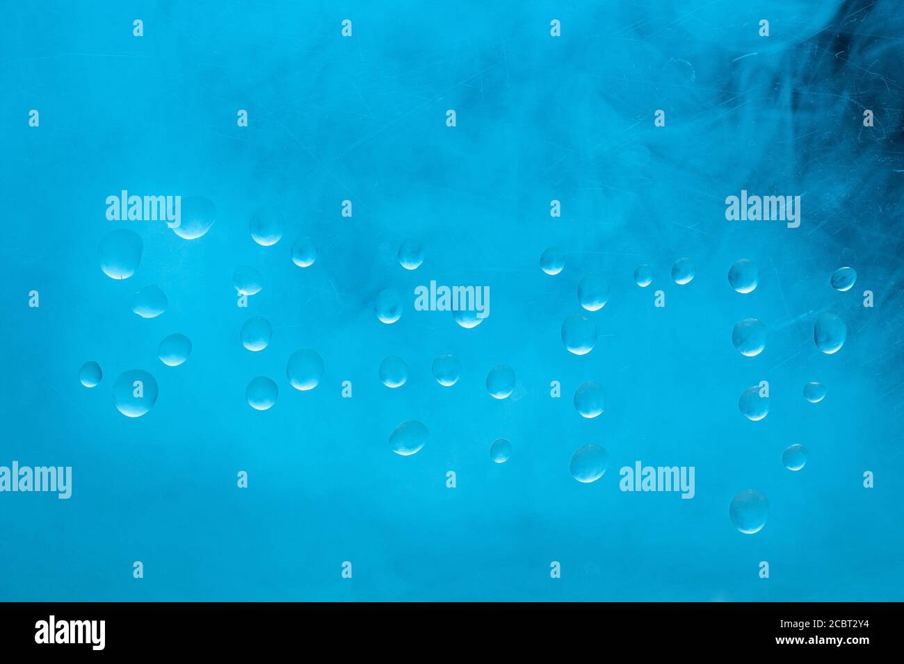 word scary of shiny water drops on a background of mysterious blue ...