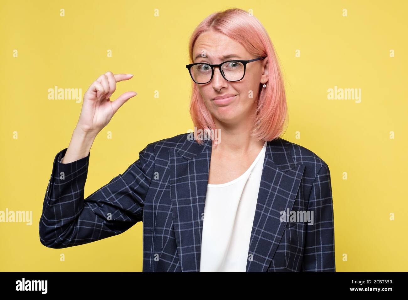 Caucasian woman showing small amount of something with fingers Stock ...