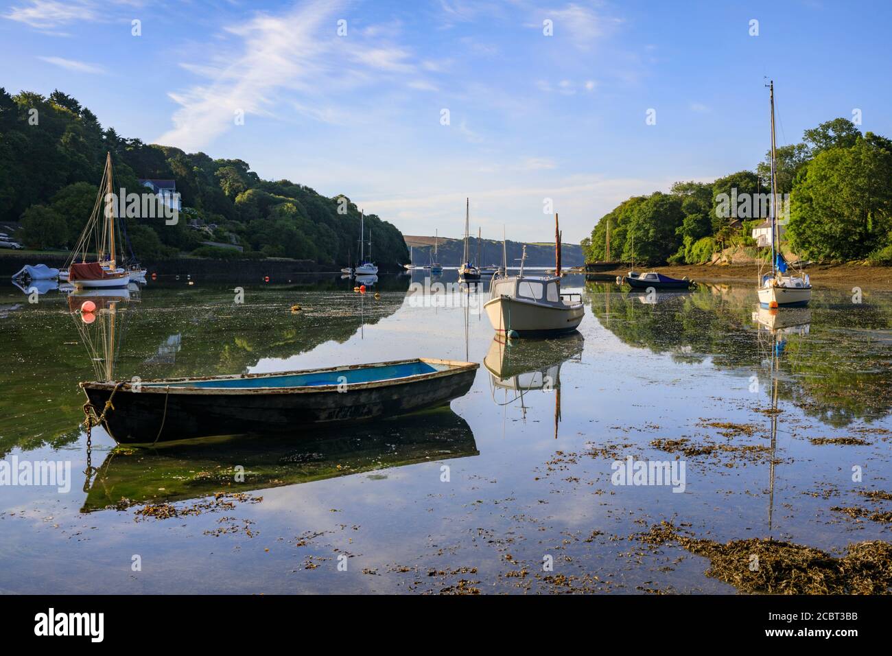 Boats on Pill Creek at Feock in Cornwall captured on a morning in mid ...