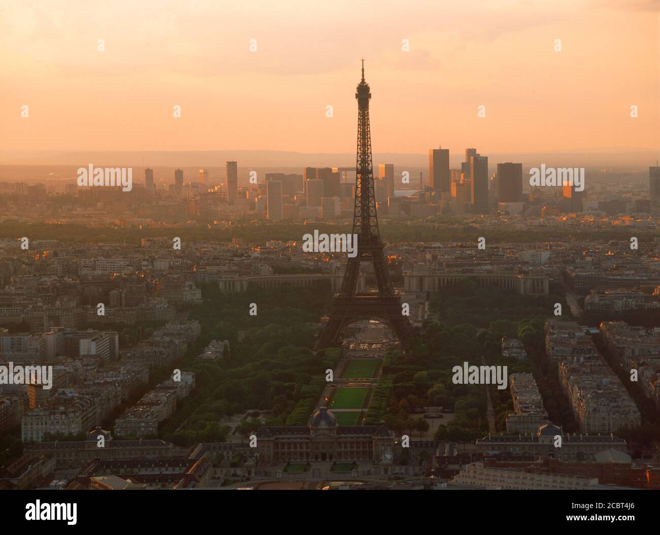 Streets and apartment buildings below Eiffel Tower in Paris at sunset ...
