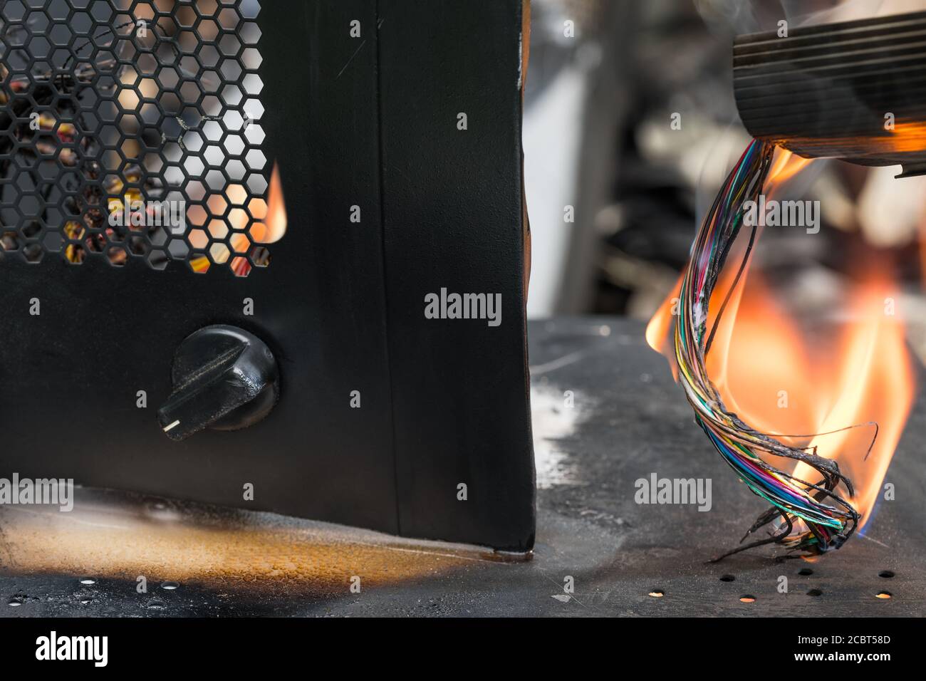 Electrical cables in flames and ruined wreck detail from traffic or ...