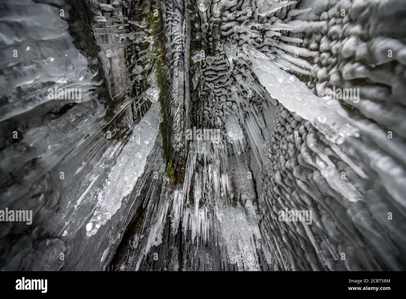 Ice stalactites hanging from the ceiling of an ice cave on Olkhon ...
