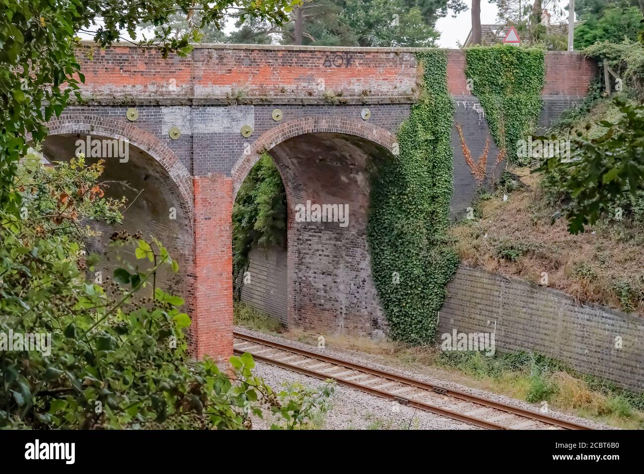 Victorian era brick built bridge over the railway line in the village ...