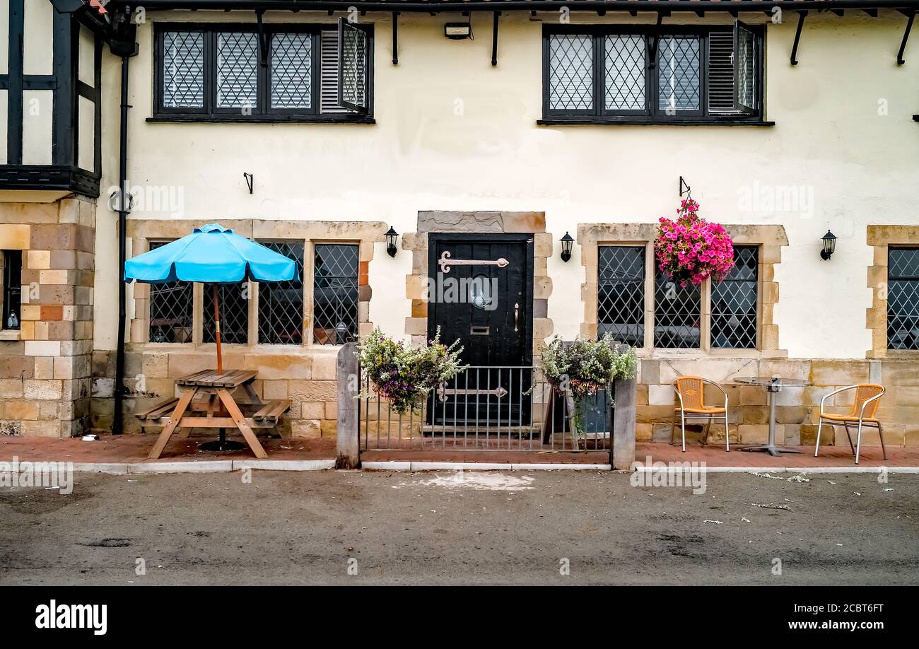 The front exterior of a tradiitonal Tudor style building used as a ...