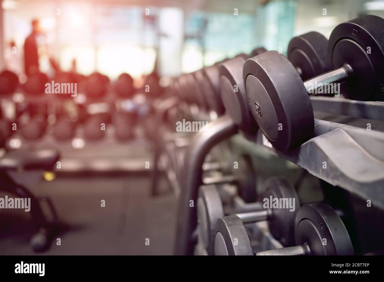 Detail of a dumbbells stand in a gym, flare effect Stock Photo - Alamy