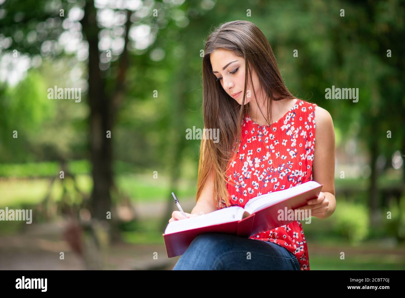 Young college student taking book hi-res stock photography and images ...