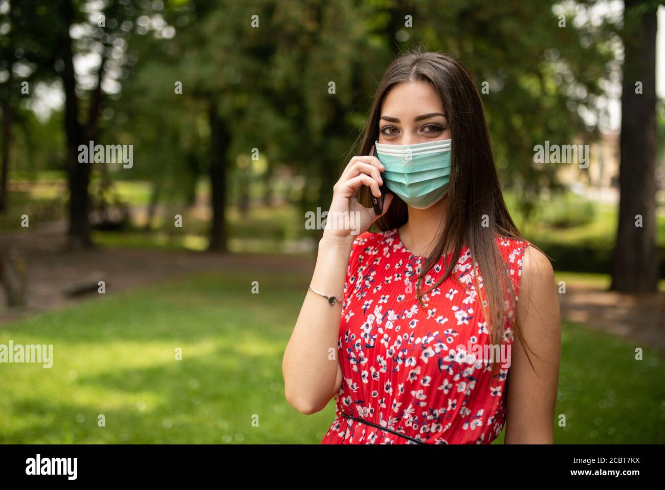 Masked woman on the phone hi-res stock photography and images - Alamy