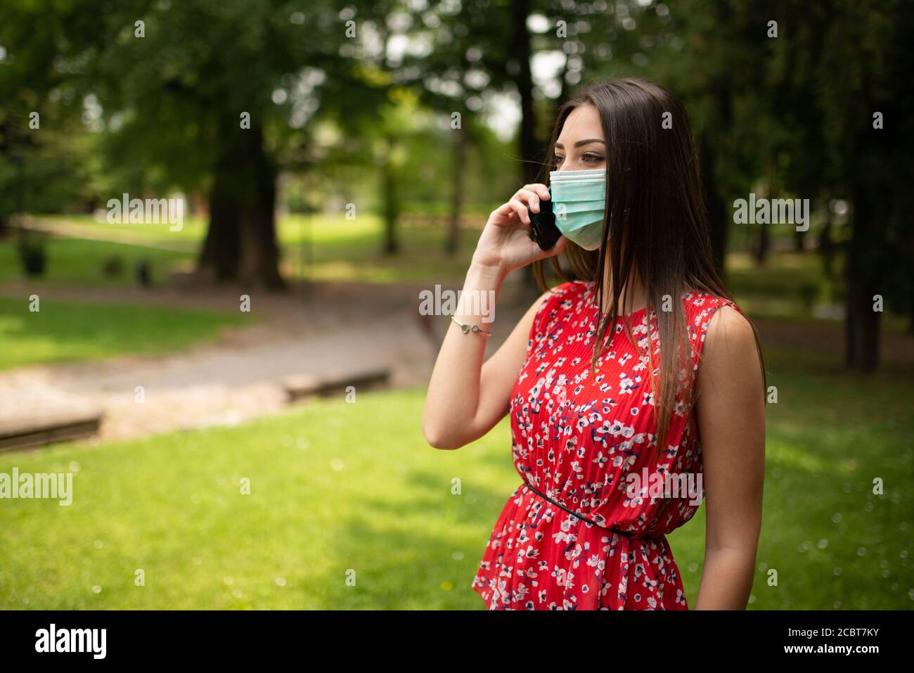 Masked woman on the phone hi-res stock photography and images - Alamy