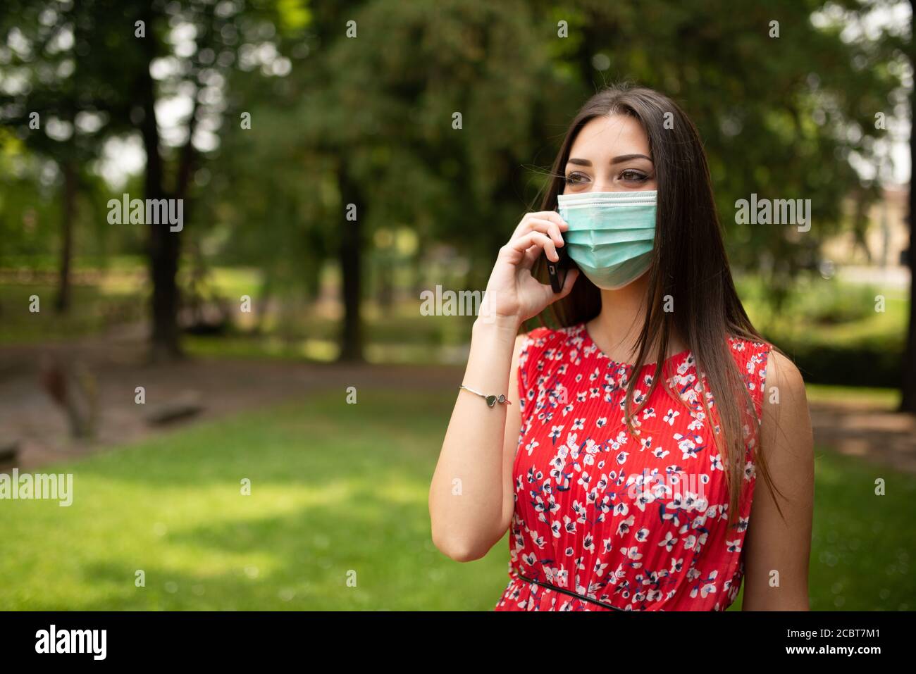 Masked woman on the phone hi-res stock photography and images - Alamy