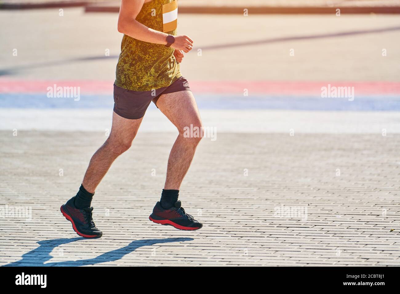 Running man. Athletic man jogging in sportswear on city road. Healthy ...