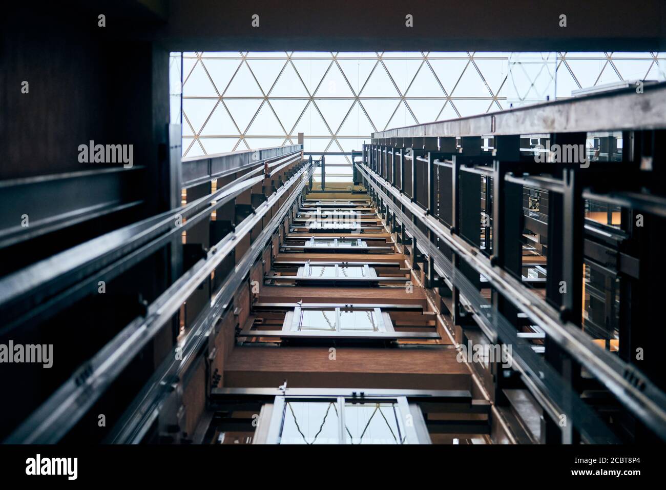 Open elevator lift shaft. Modern architecture with transparent ceiling ...