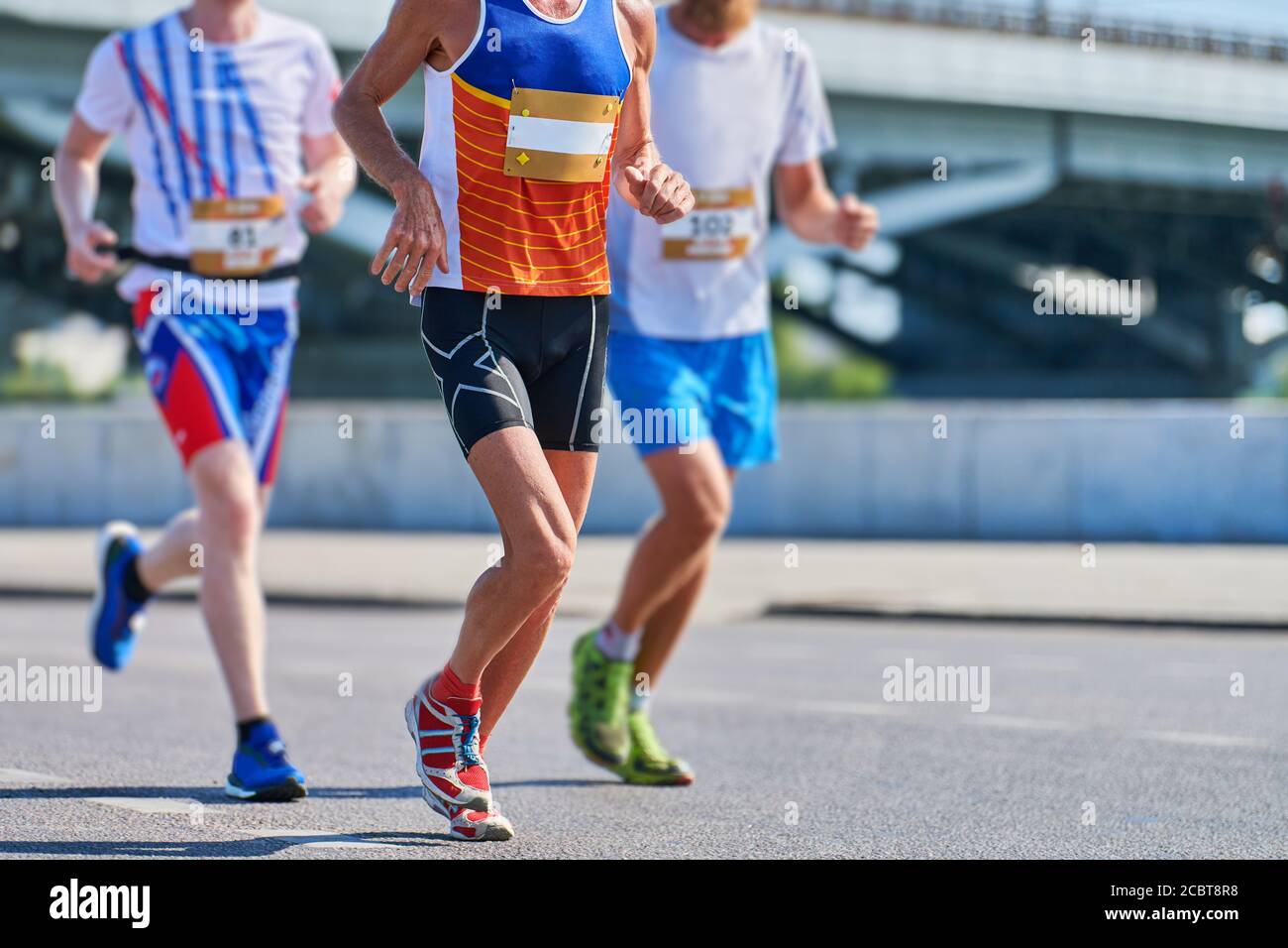 Marathon runners on city road. Running competition. Street sprinting ...