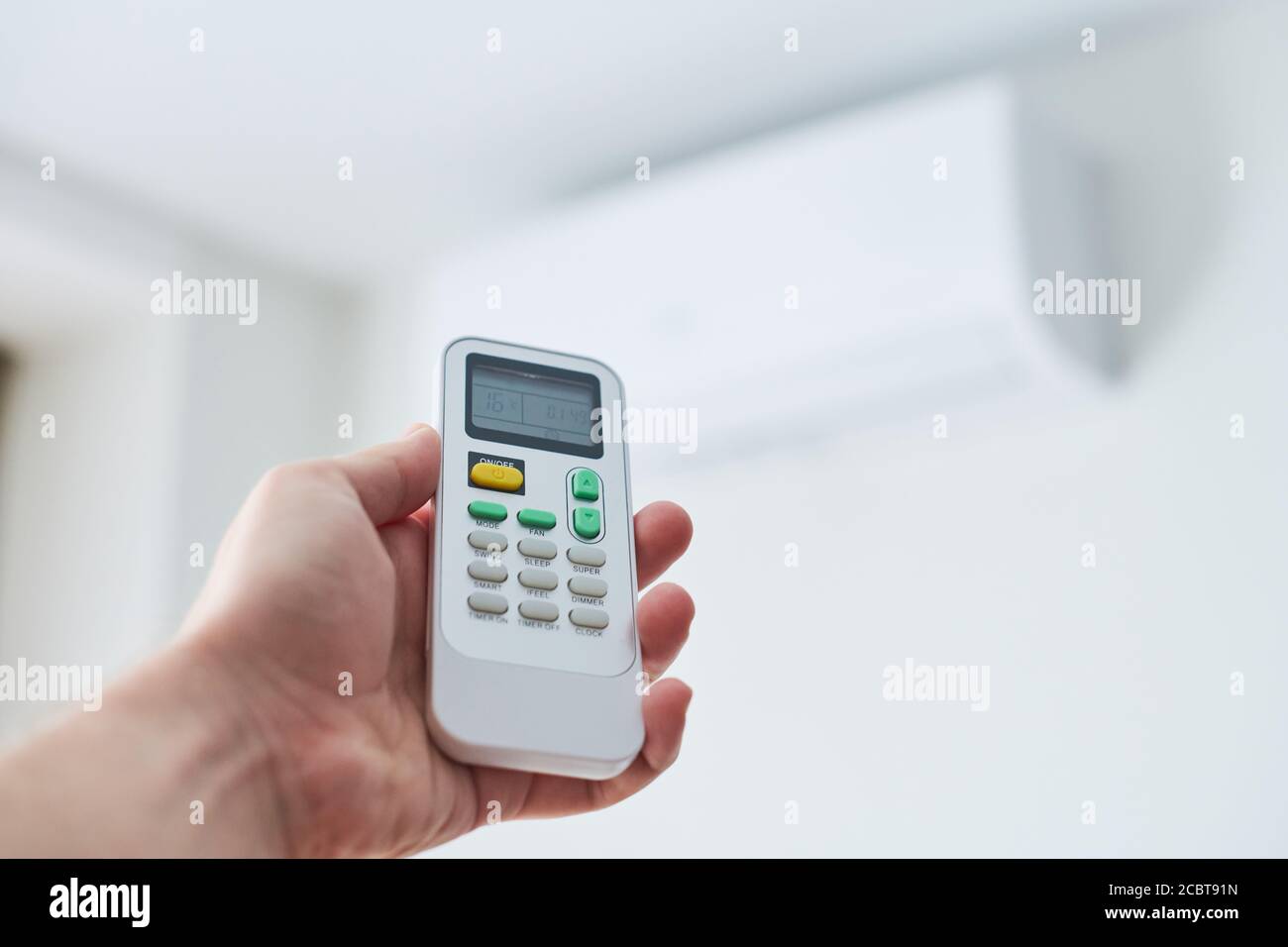 Air condition remote control. Hand with room conditioner remote control ...