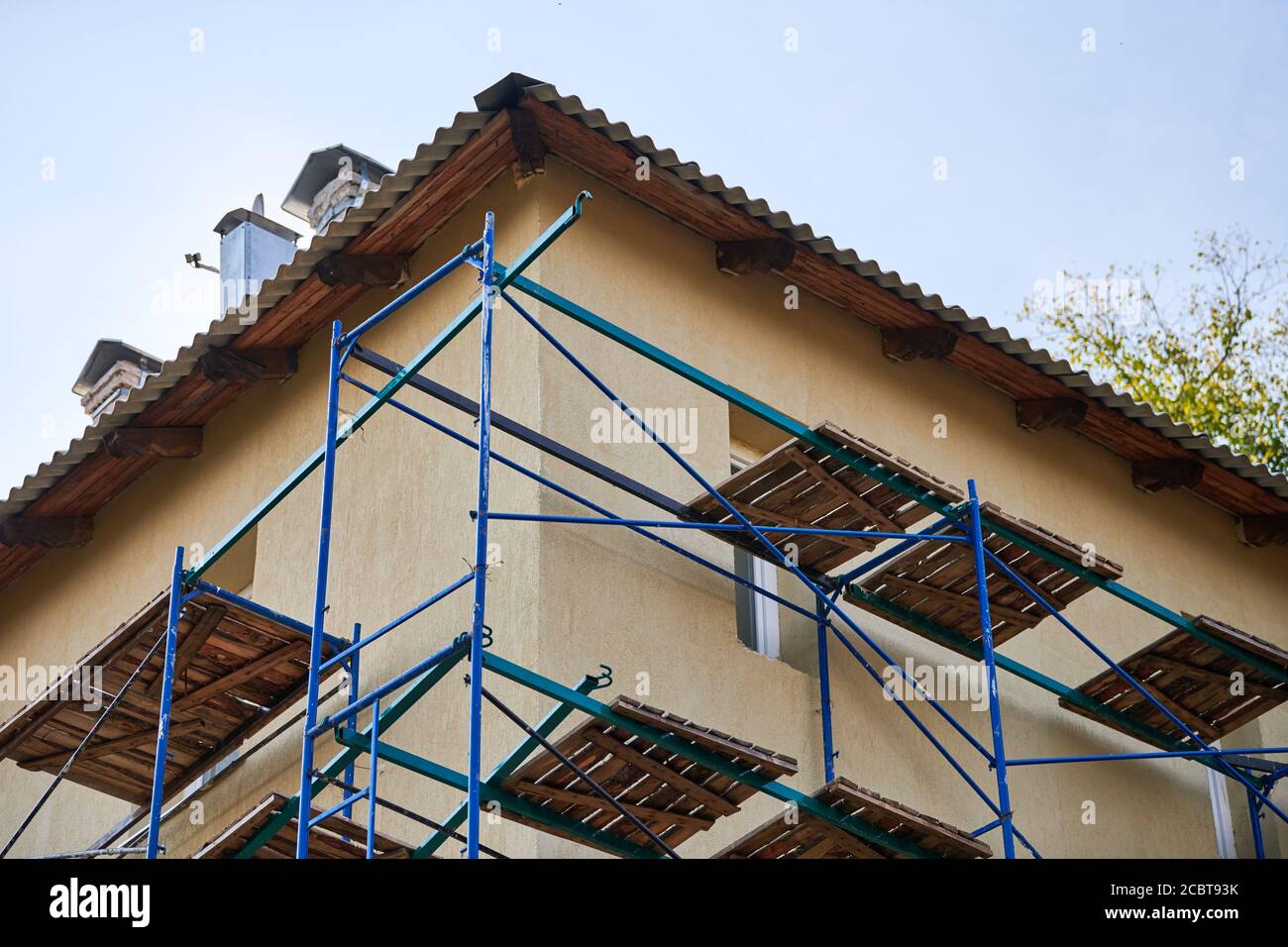 Scaffolding on construction site. Incomplete building and decoration ...