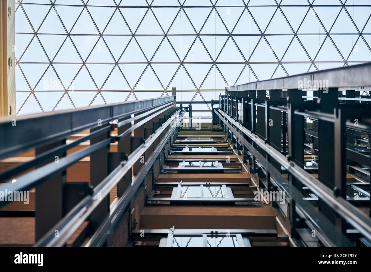 Open elevator lift shaft. Modern architecture with transparent ceiling ...