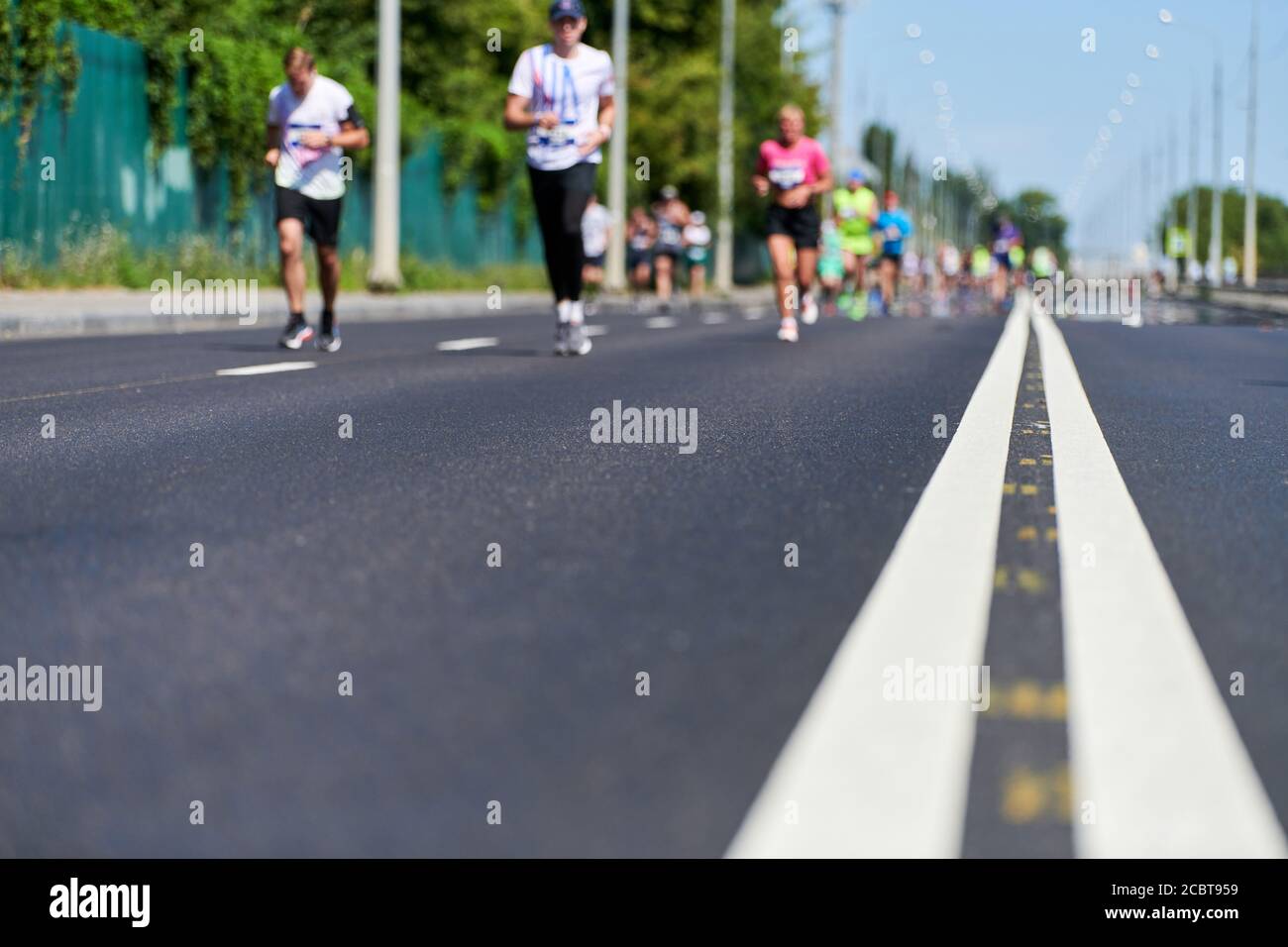 Marathon runners on city road. Running competition, copy space. Street ...