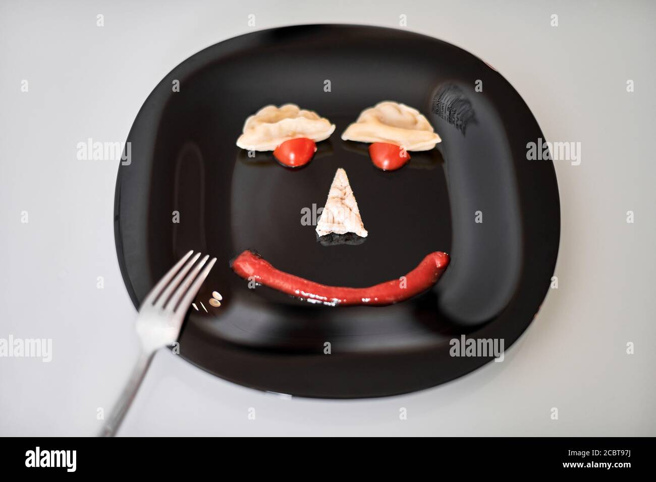 Food face, funny dumpling and ketchup. Smiling face on plate. Food art ...