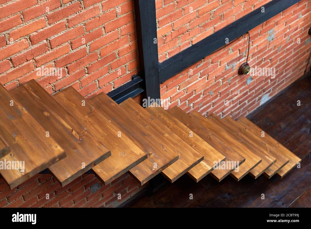 Stairs in loft apartment. Staircase without railing. Modern hipster ...
