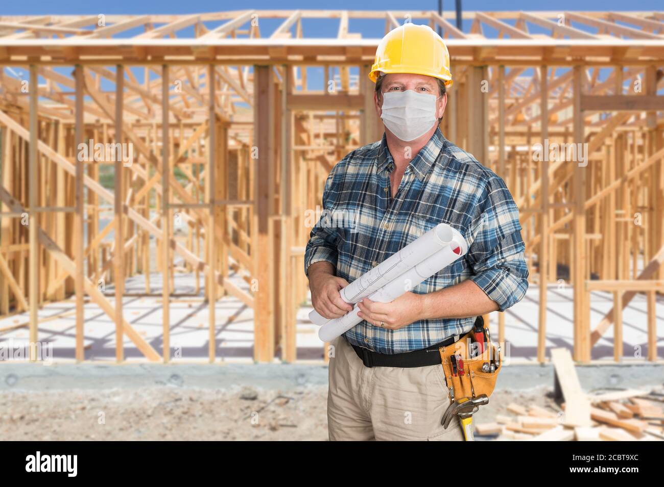 Male Contractor In Hard Hat Wearing Medical Face Mask During ...