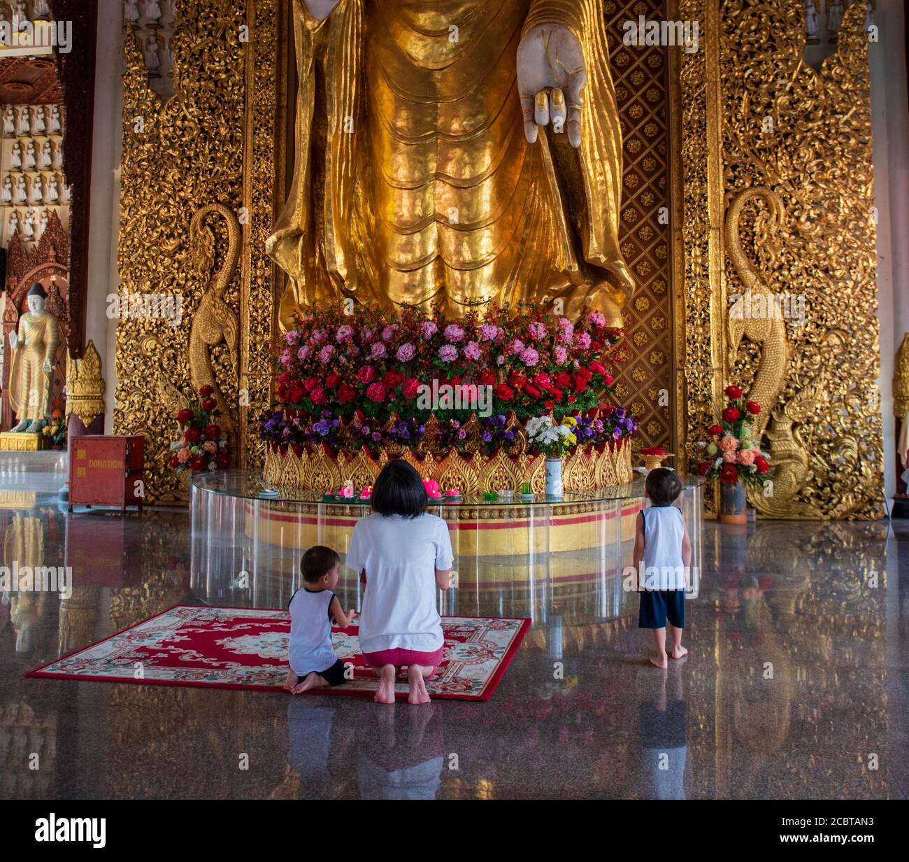 Penang, Malaysia -- March 7, 2016. Mother and two young sons at a ...