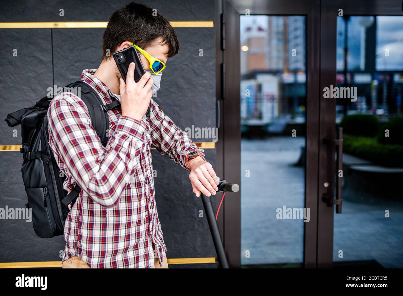 Male courier wearing protective face mask arrived at delivery address ...