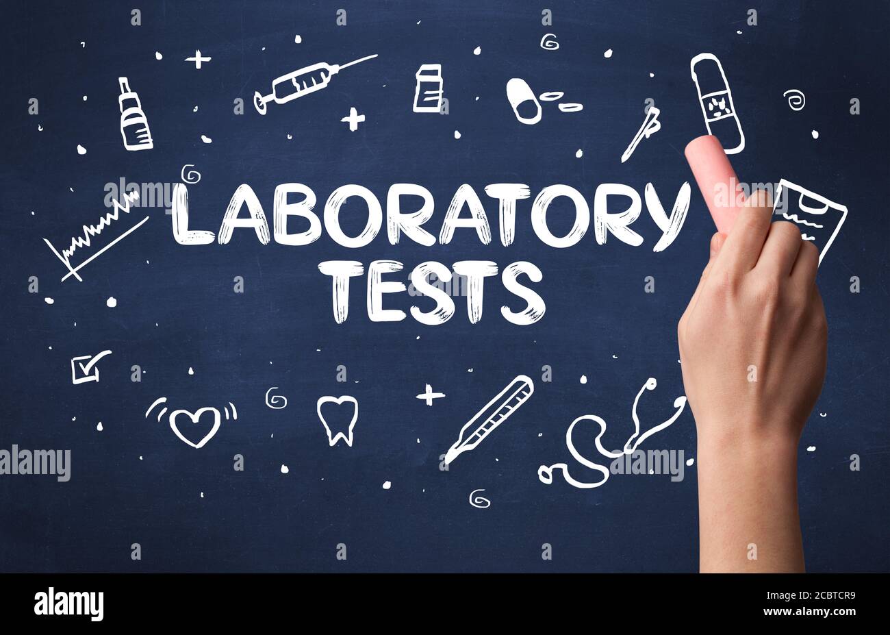 Hand drawing LABORATORY TESTS inscription with white chalk on ...