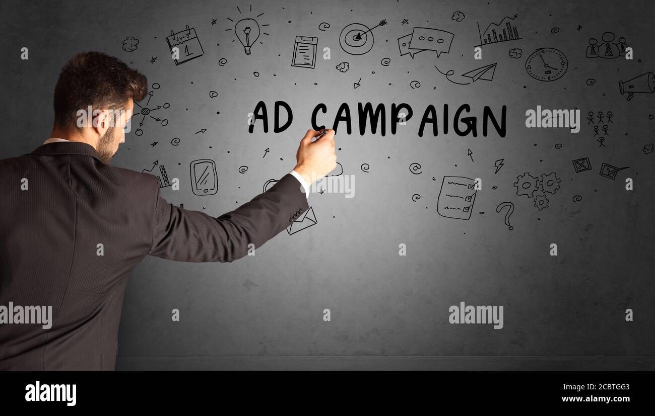 businessman drawing a creative idea sketch with AD CAMPAIGN inscription ...