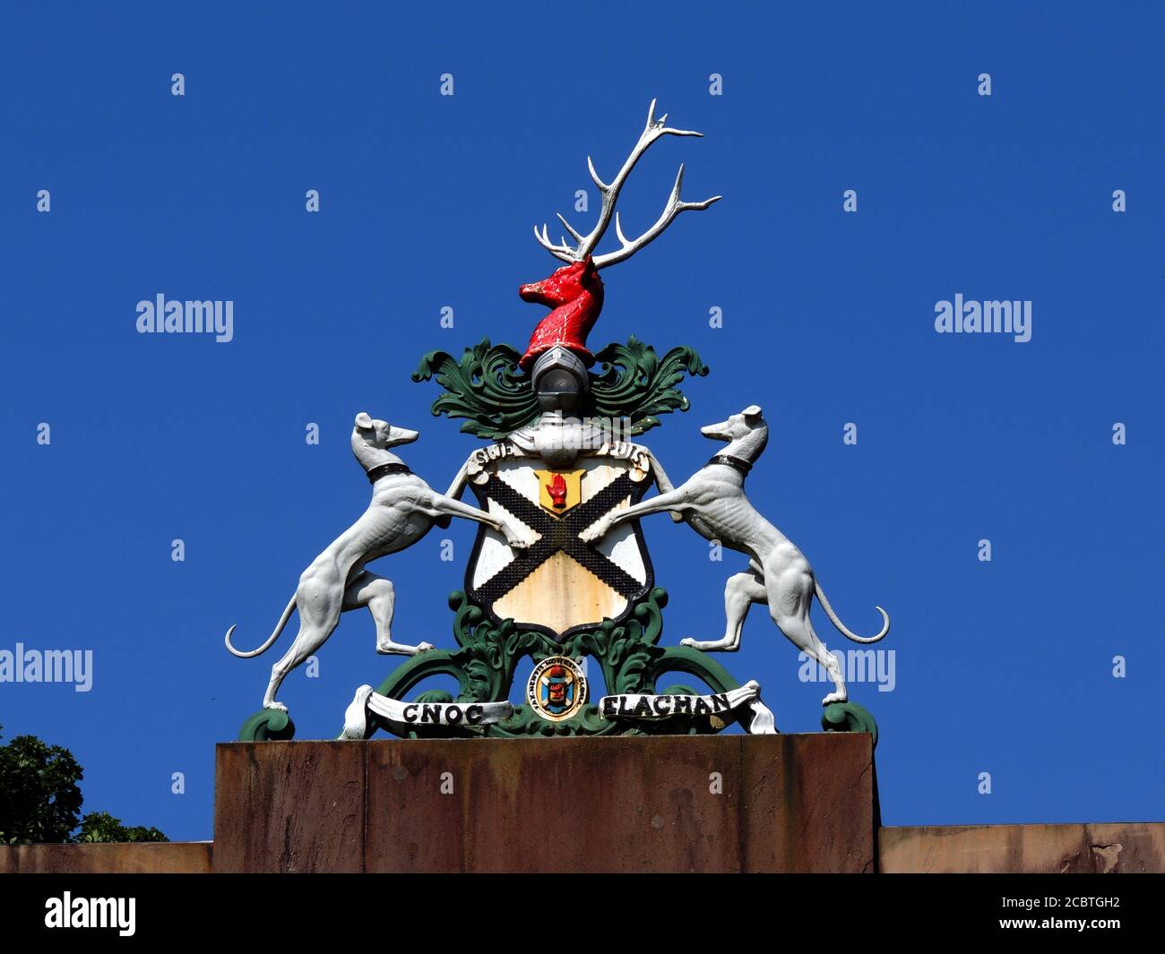 The crest of the clan Colquhoun sits above the gates at the former ...