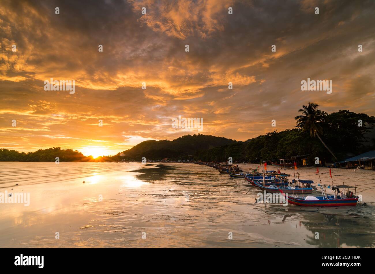 Beautiful sunset with row of fishing boat near fishing village in the ...
