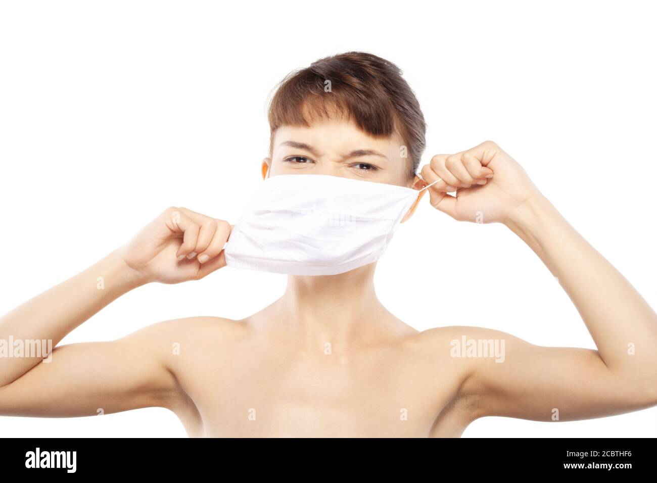 angry sad girl pulling her medical face mask for protection from corona ...
