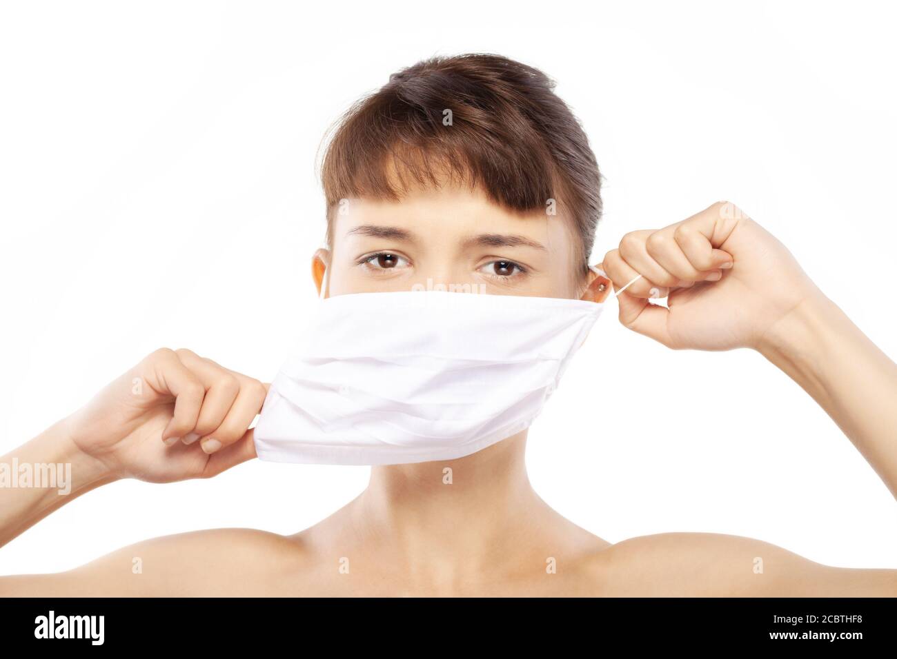 angry sad girl pulling her medical face mask for protection from corona ...