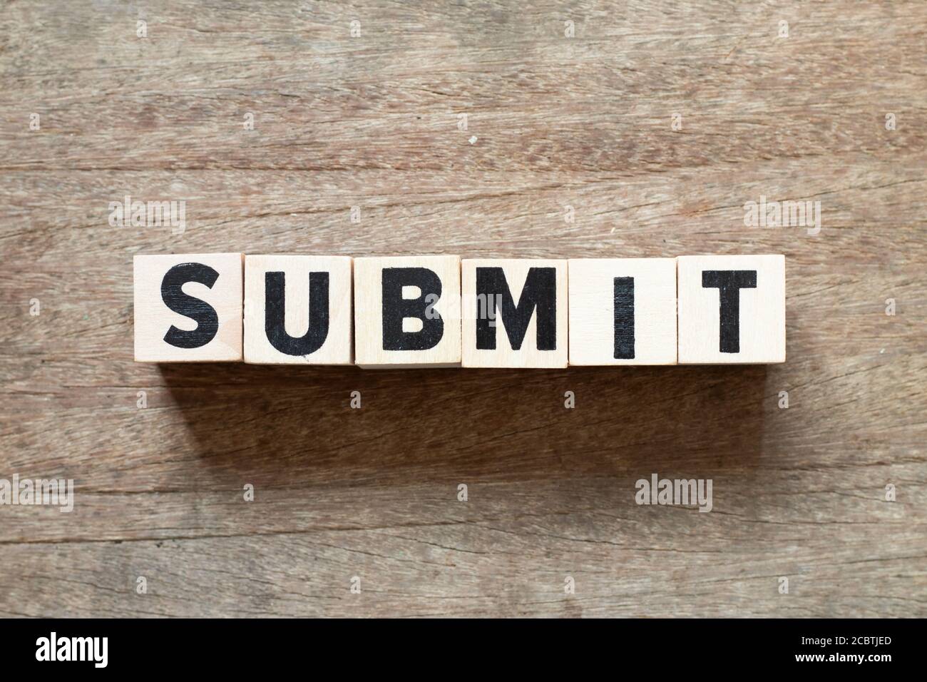 Alphabet letter block in word submit on wood background Stock Photo - Alamy
