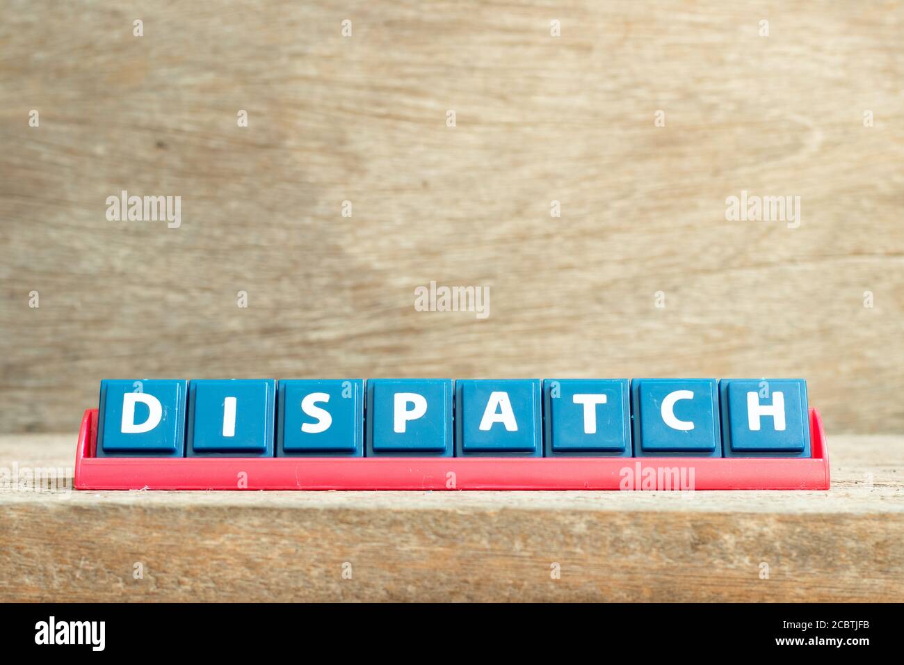 Tile letter on red rack in word dispatch on wood background Stock Photo ...