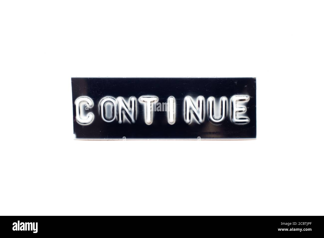 Embossed letter in word continue in black banner on white background ...