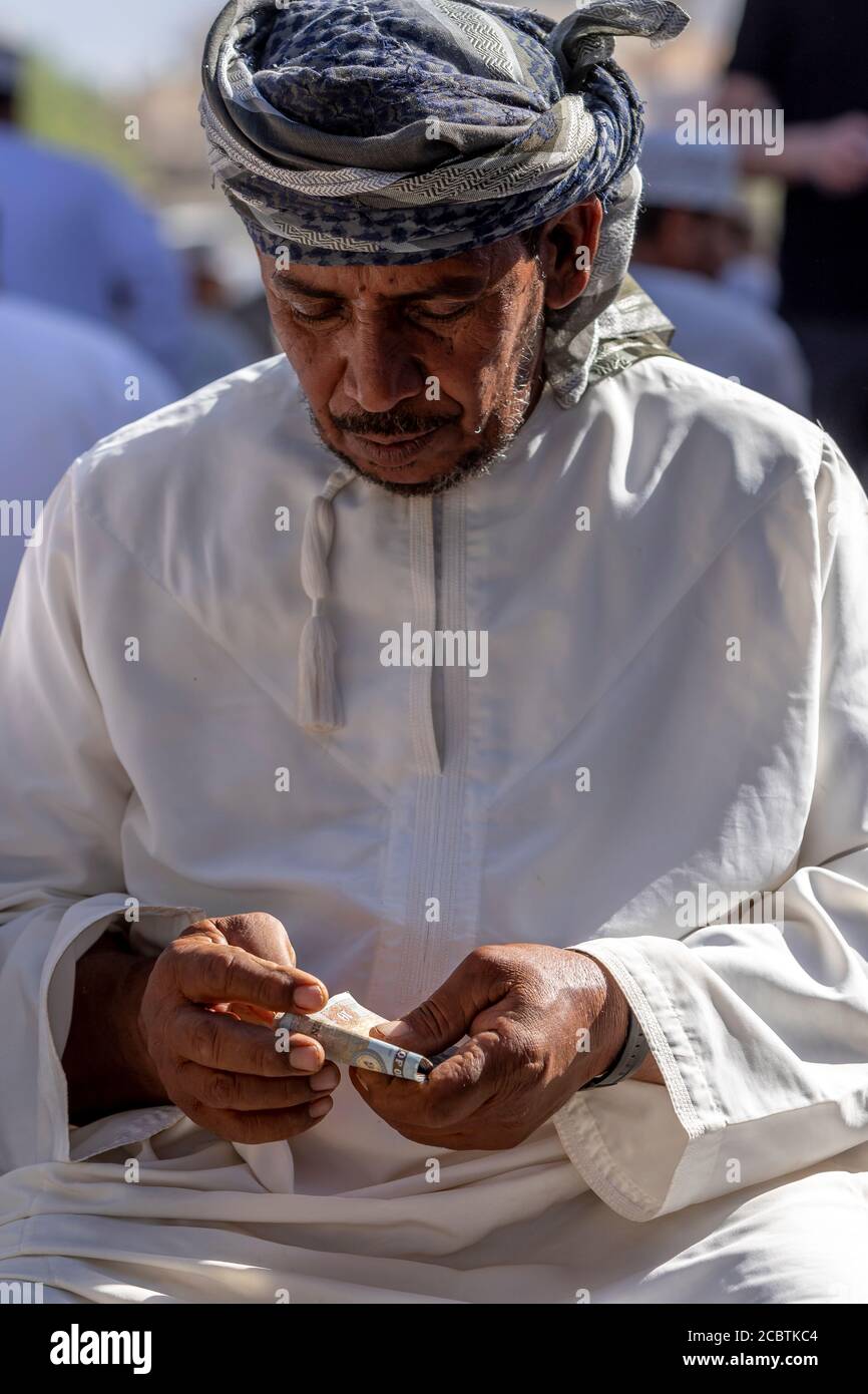 portrait of omani merchant attending the goat auction Stock Photo - Alamy