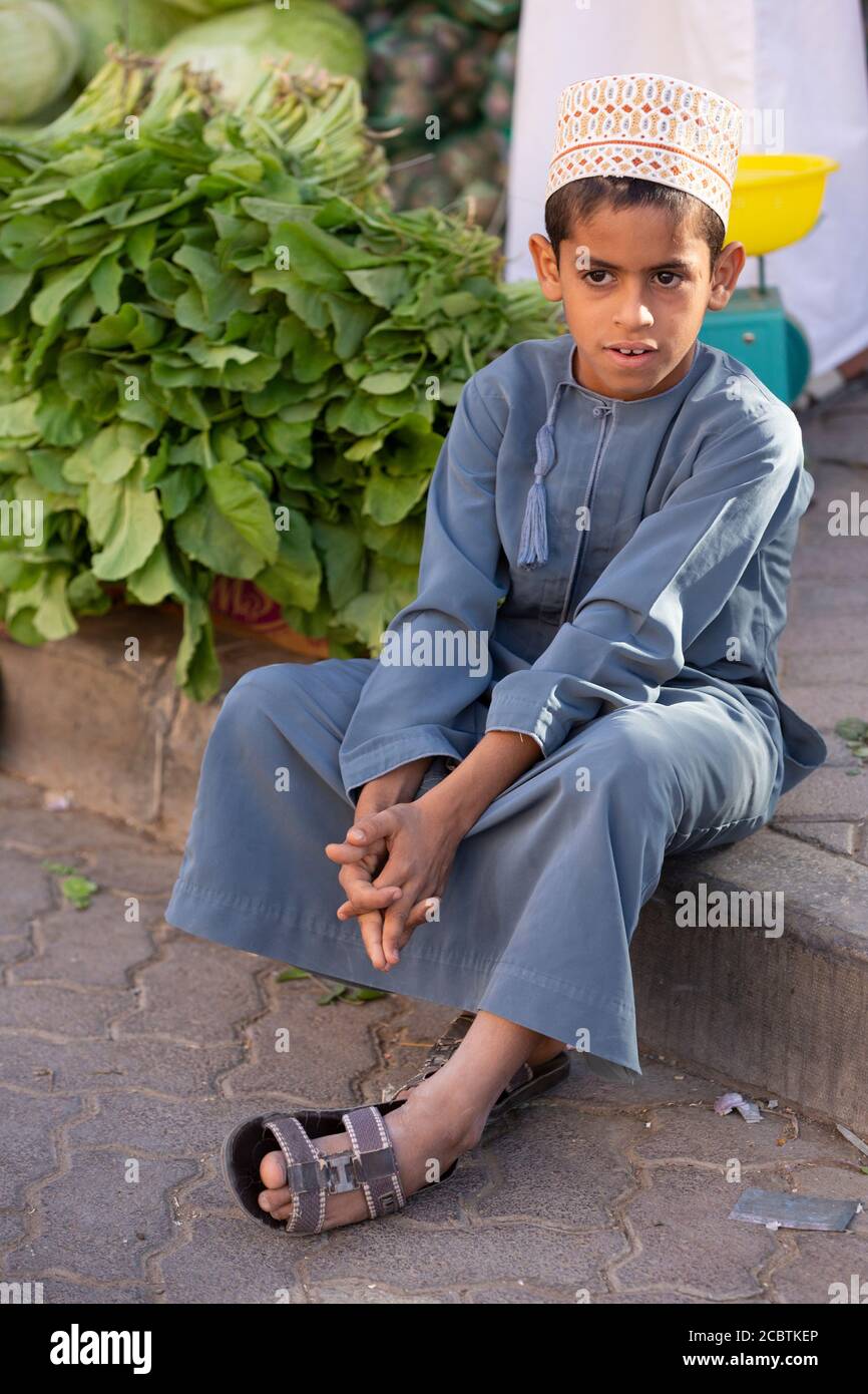 Omani Kid attending the Friday cattle auctions at Nizwa souq Stock ...