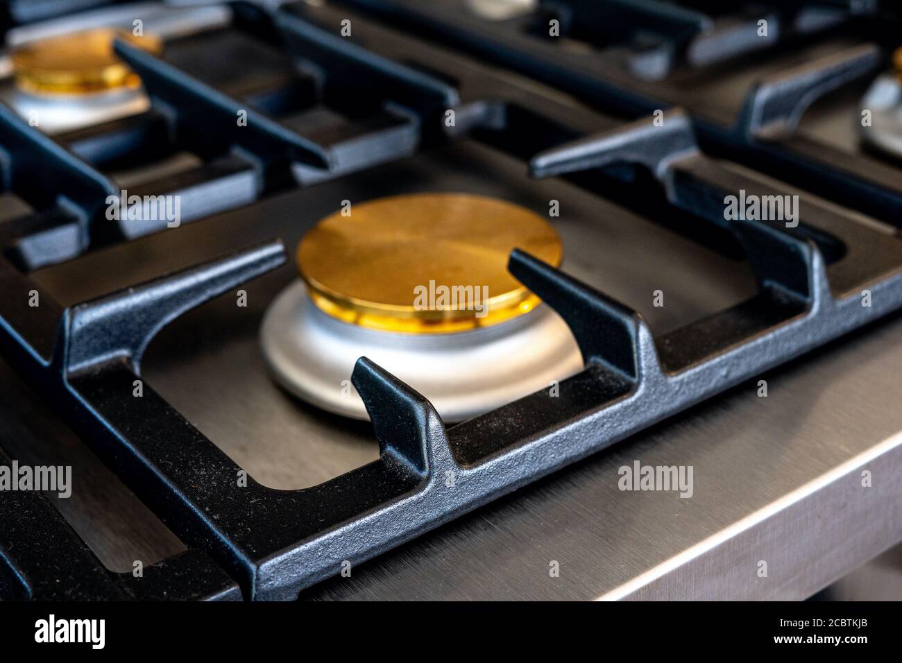 Gas stove and embedded electric oven at brand new modern wooden kitchen ...