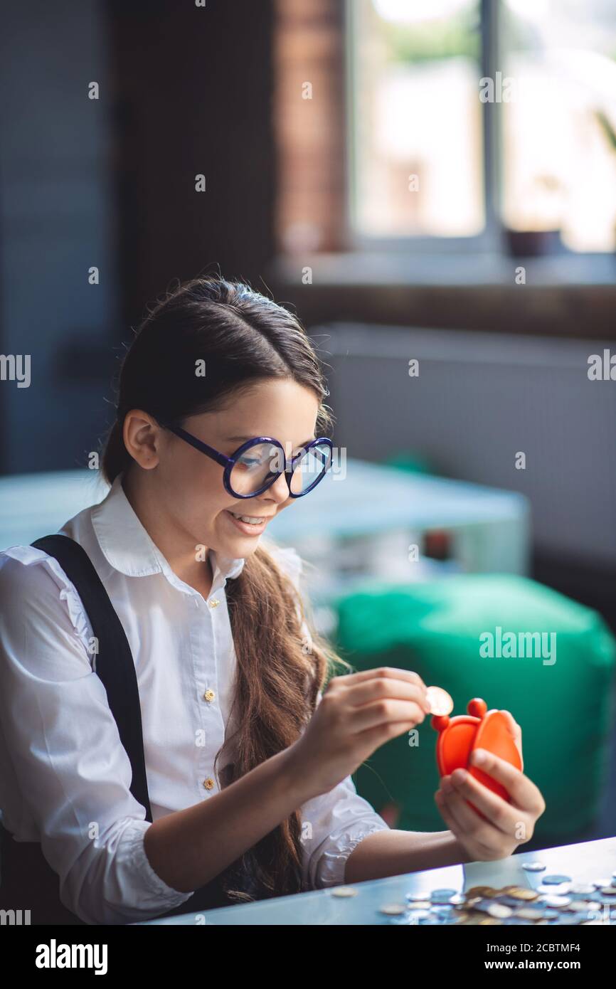 Girl counting coins hi-res stock photography and images - Alamy