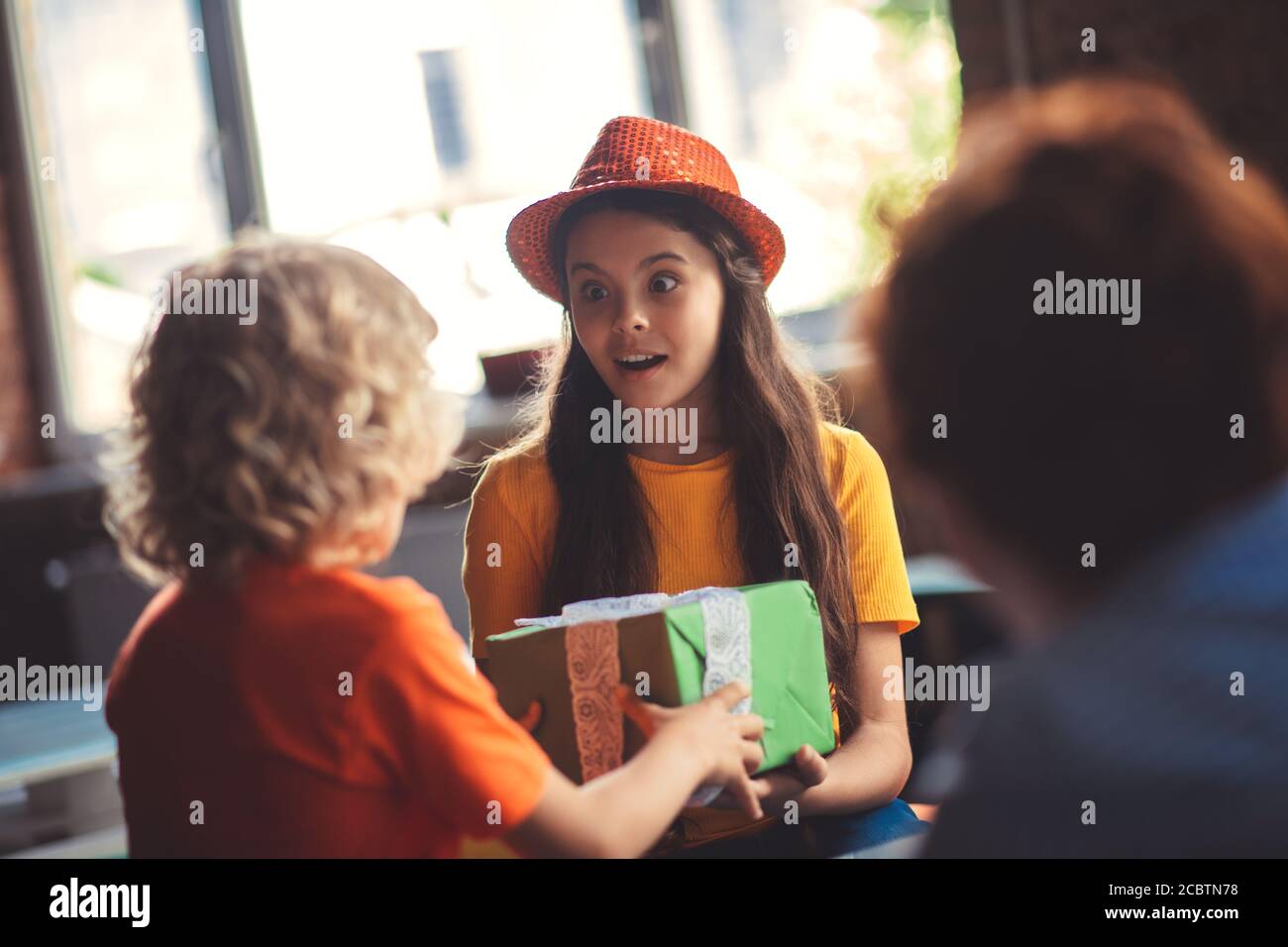 Pretty girl receiving a gift on her birhday Stock Photo - Alamy