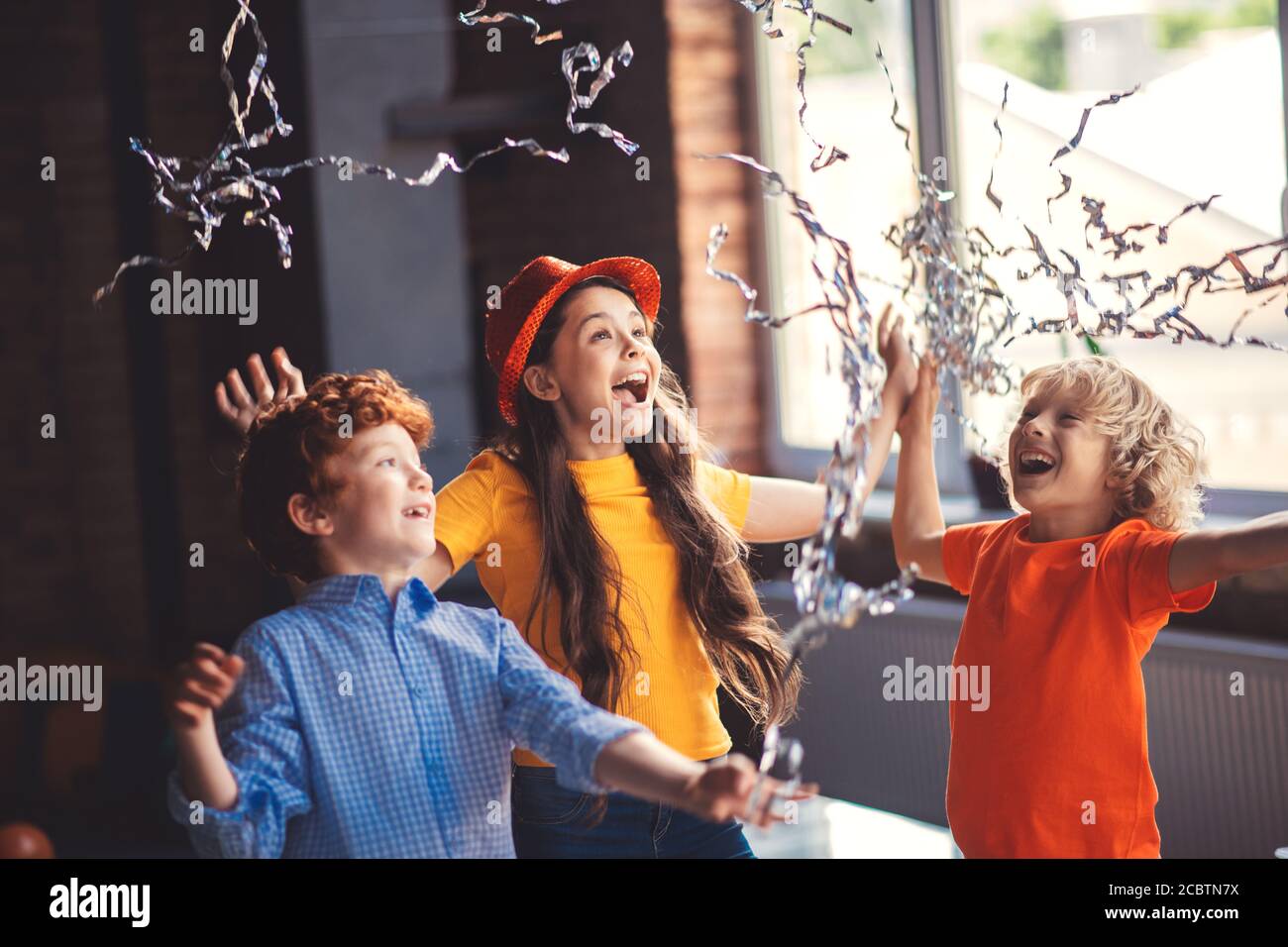 Three cute kids celebrating bithday and enjoying Stock Photo - Alamy