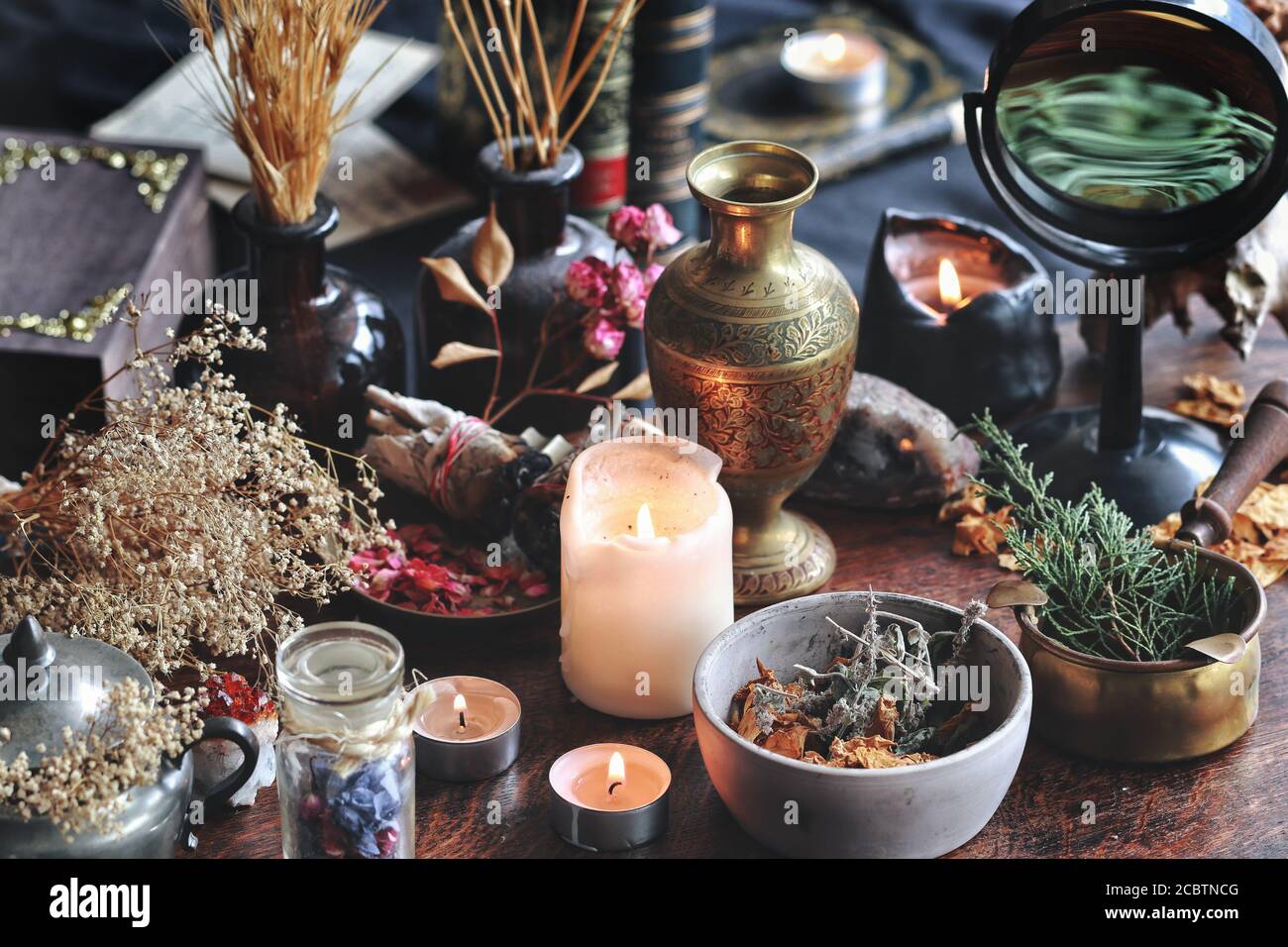 Dried plants, herbs and yellow rose flower petals in a grey, dirty clay ...
