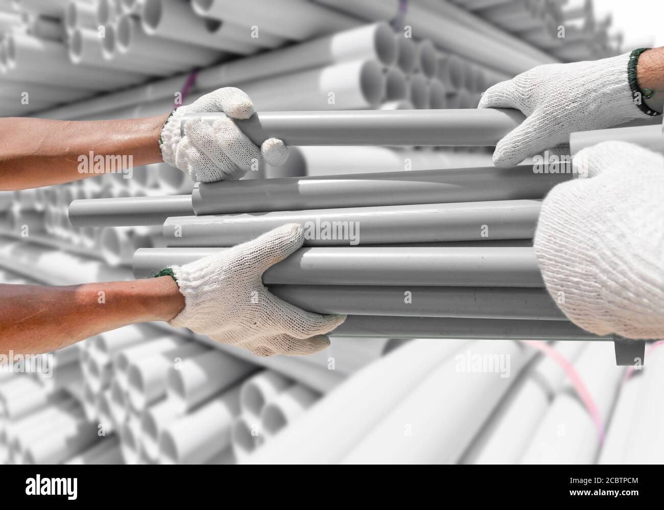 Plumber choose PVC pipes from bundle Stock Photo - Alamy