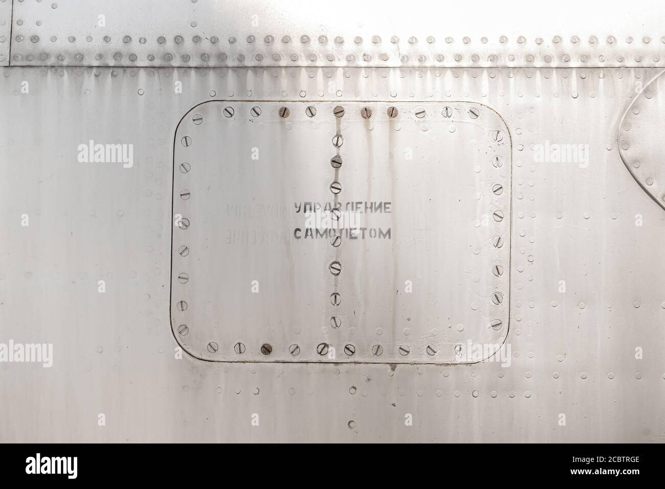 Old silver metal surface of the aircraft fuselage with rivets. Selected ...