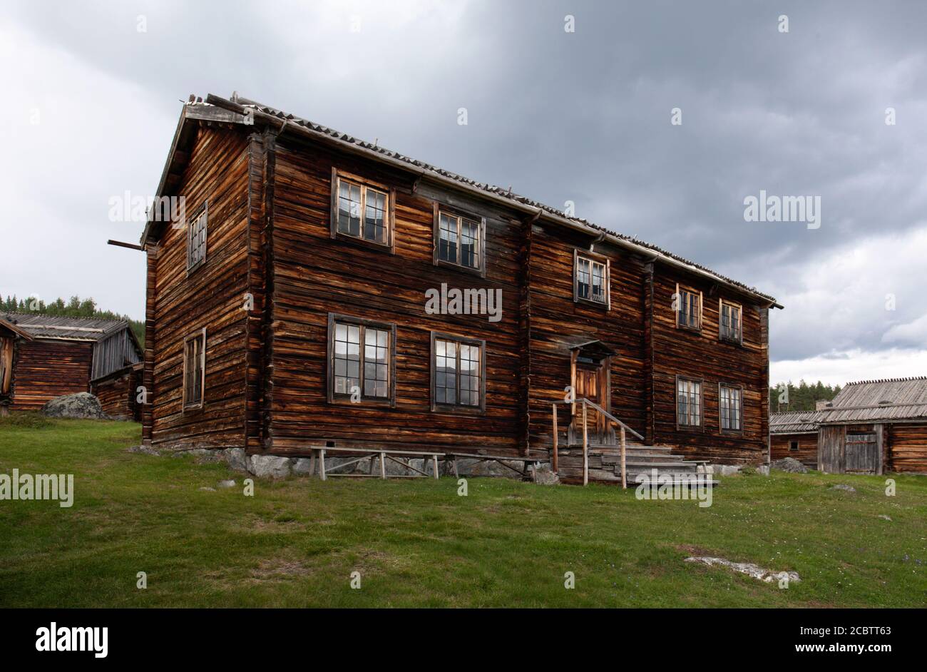 Wooden warehouse, storehouse, farmhouse far out in rural country. Trees ...